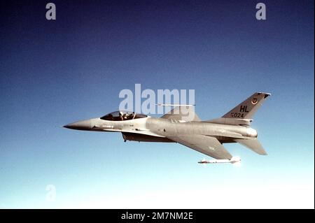 An air-to-air right side view of an F-16 Fighting Falcon aircraft ...