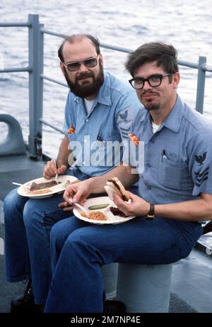 Crewmen aboard the destroyer USS ARTHUR W. RADFORD (DD-968) pull a ...