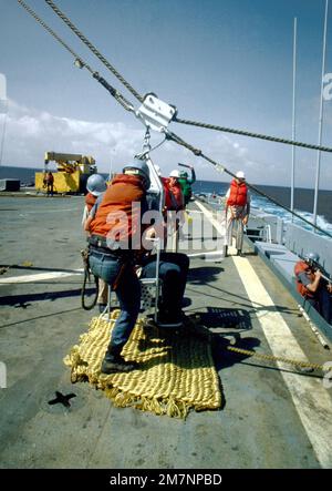 Crewmen aboard the destroyer USS ARTHUR W. RADFORD (DD-968) participate ...