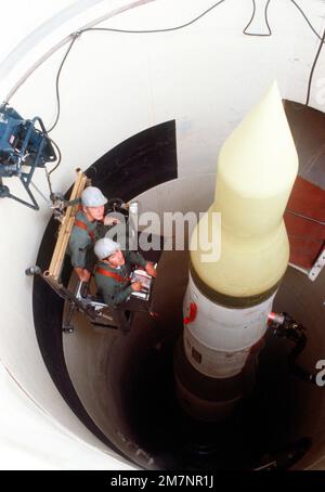 Two missile maintenance crewmen perform an electrical check on an LGM ...
