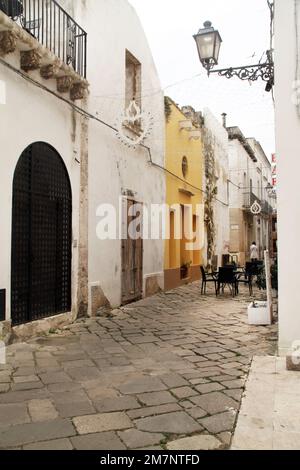 Racale, Italy. Narrow alleyway in the historical center with a natural ...