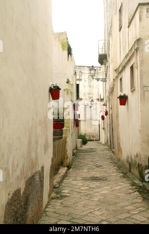 Racale, Italy. Narrow alleyway in the historical center with a natural ...