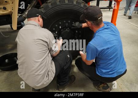 Students in the JLTV Phase II course install a tire. (Army photo by ...