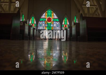 Enterior with arches, crosses and stained glass window inside Catholics ...