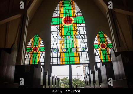 Enterior with arches, crosses and stained glass window inside Catholics ...