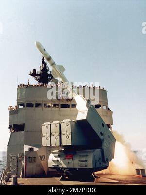 A Harpoon missile is launched from the guided missile cruiser USS ...