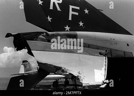 A view of damage caused to an F-4 Phantom II aircraft that was parked ...