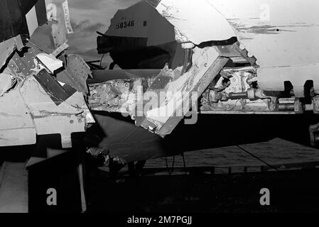 A view of damage caused to the tail section and right wing tip of an F ...