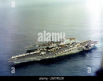 An aerial port view of the aircraft carrier USS MIDWAY (CV 41), right ...