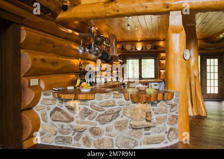 Kitchen with curved bar constructed with fieldstones and porous rocks ...