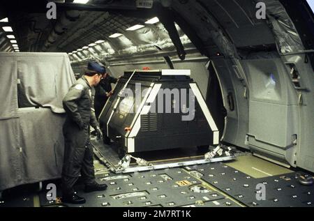 Interior view of a KC-10 Extender aircraft as cargo is positioned on a ...