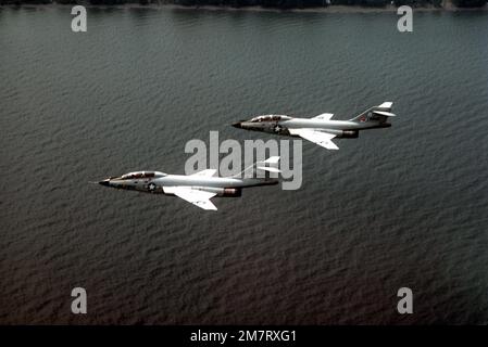 A left side view of the two F-101 Voodoo aircraft landing, with their ...