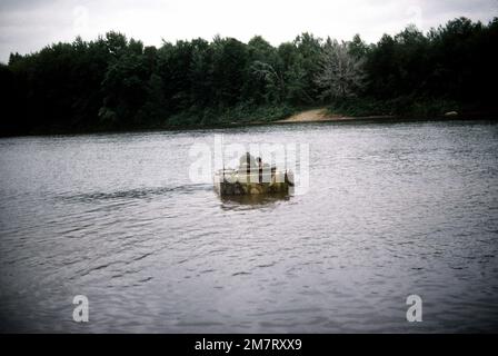 Soldiers aboard an M-113 armored personnel carrier prepare to move out ...