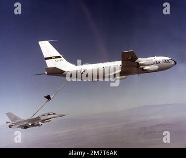 An air-to-air right side of an F-16B Fighting Falcon aircraft with a ...