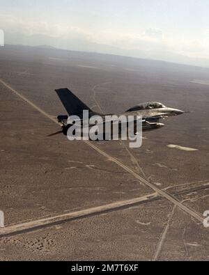 An air-to-air right side view of an F-16B Fighting Falcon aircraft with ...