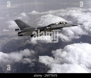 An air-to-air right side view of an F-16B Fighting Falcon aircraft with ...