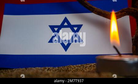 Israeli flag and burning candles in front of it, Holocaust memory day ...