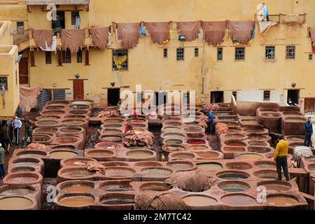 Fez, Morocco - workers soak animal hides on stone vessels with dyes at ...
