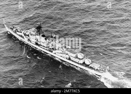 An aerial port quarter view of the destroyer COMPTE DE GRASSE (DD-974) bottom, the battleship ...