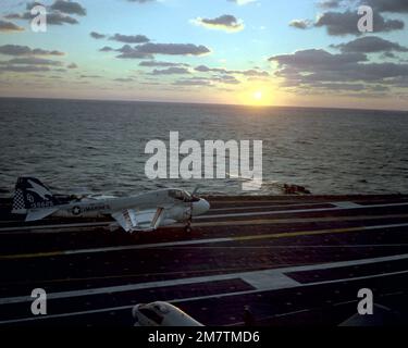 An A-6E Intruder aircraft catches the arresting cable as it touches ...