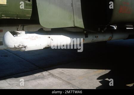 A close-up view of a PAVE SPIKE designator pod, left, and two GMU-12 ...