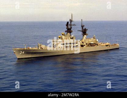 The guided missile cruiser USS BIDDLE (CG-34) passes near the bow of the nuclear-powered guided ...