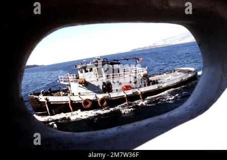 The large harbor tug NASHUA (YTB-774) moves into assist the tank ...