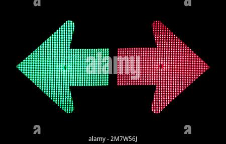 Wrong direction. Red arrow light on traffic lights on black background ...