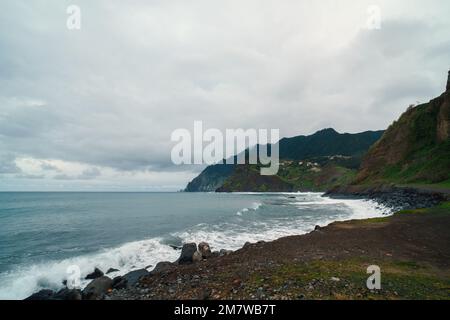 The splashing wave sat the rocky coast of Madeira Island bay Stock ...