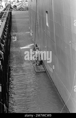 Crewmen aboard the destroyer USS JOHN HANCOCK (DD-981) plot the ship's ...