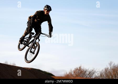 People ride and jump their mountain bikes at a BMX and pump track in ...
