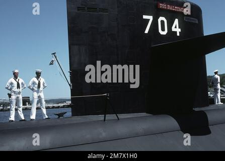 Crewmen stand on the deck of the nuclear-powered attack submarine USS ...