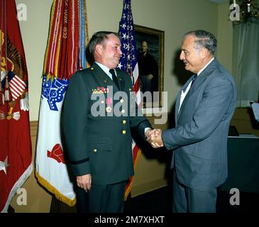 Secretary of the Army John O. Marsh passes the command flag to GEN John ...