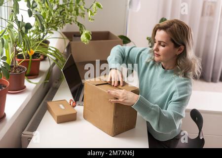 Cropped view of seller holding shipping label in online web store Stock ...