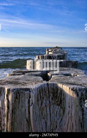 Groynes jut into the horizon in the Baltic Sea. Breakwater at the sea ...