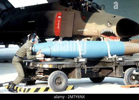 A Korean loading crew member prepares a Mark 84 2,000-pound bomb, prior ...