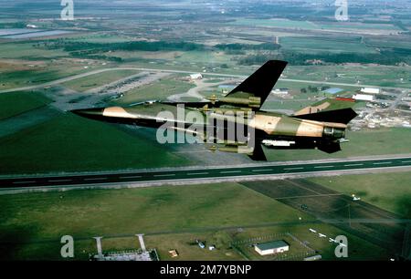 A left underside air-to-air view of an F-111 aircraft carrying a full ...