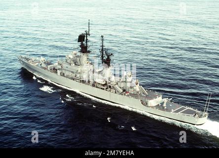 An aerial port quarter view of the destroyer COMPTE DE GRASSE (DD-974) bottom, the battleship ...