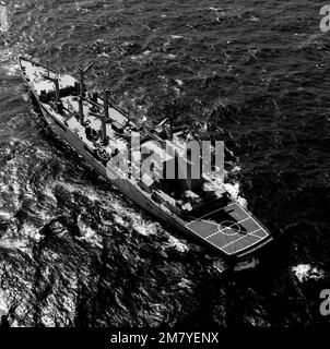 Aerial port quarter view of the oiler USS MERRIMACK (AO 179) underway ...