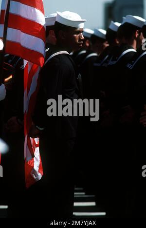 Crewmen stand at parade rest during commissioning ceremonies for the ...