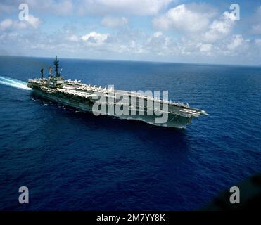 A bow view of the USS KITTY HAWK (CV-63) as crewmen form the number ...