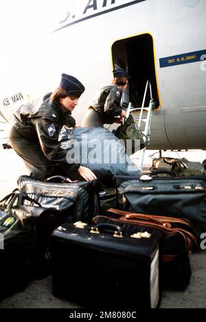 First LT. Terri Ollinger, co-pilot, assembles a map in the passenger ...
