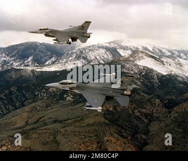 An air-to-air left side view of an F-16 Falcon aircraft assigned to the ...