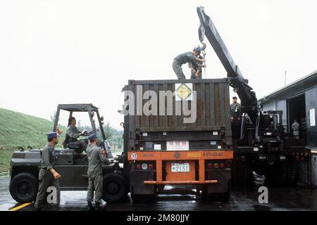 Korean troops use a truck crane to unload an open flatrack container ...