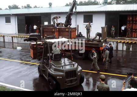 Korean troops use a forklift to remove crates of 30mm munitions from an ...