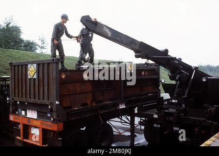 Korean troops use a truck crane to unload an open flatrack container ...