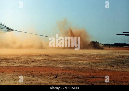 A pallet of equipment skids along the ground after being pulled from ...