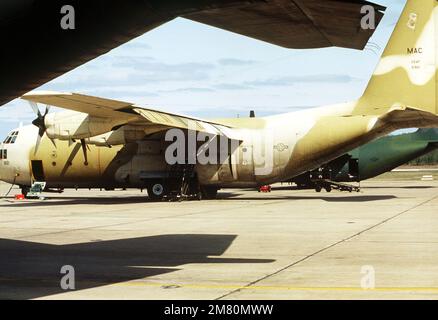A camouflaged C-130 Hercules aircraft, left, and two CH-46 helicopters ...