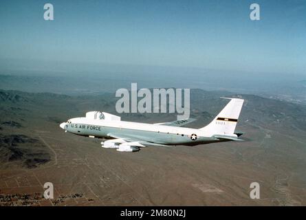 An air-to-air left side view of an NKC-135 Airborne Laser Laboratory ...