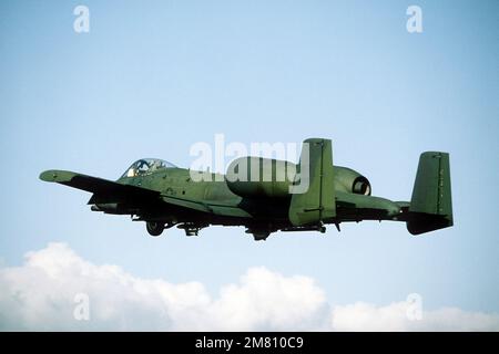 A left rear view of an A-10 Thunderbolt II aircraft taking off with a ...